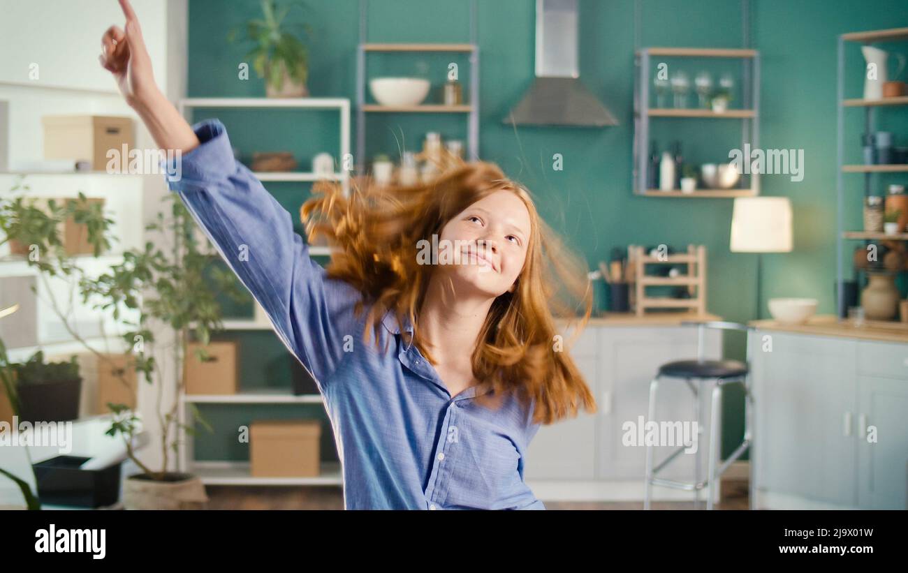 Cute Red-haired Teenage Girl Dancing Vigorously in Modern Kitchen at ...