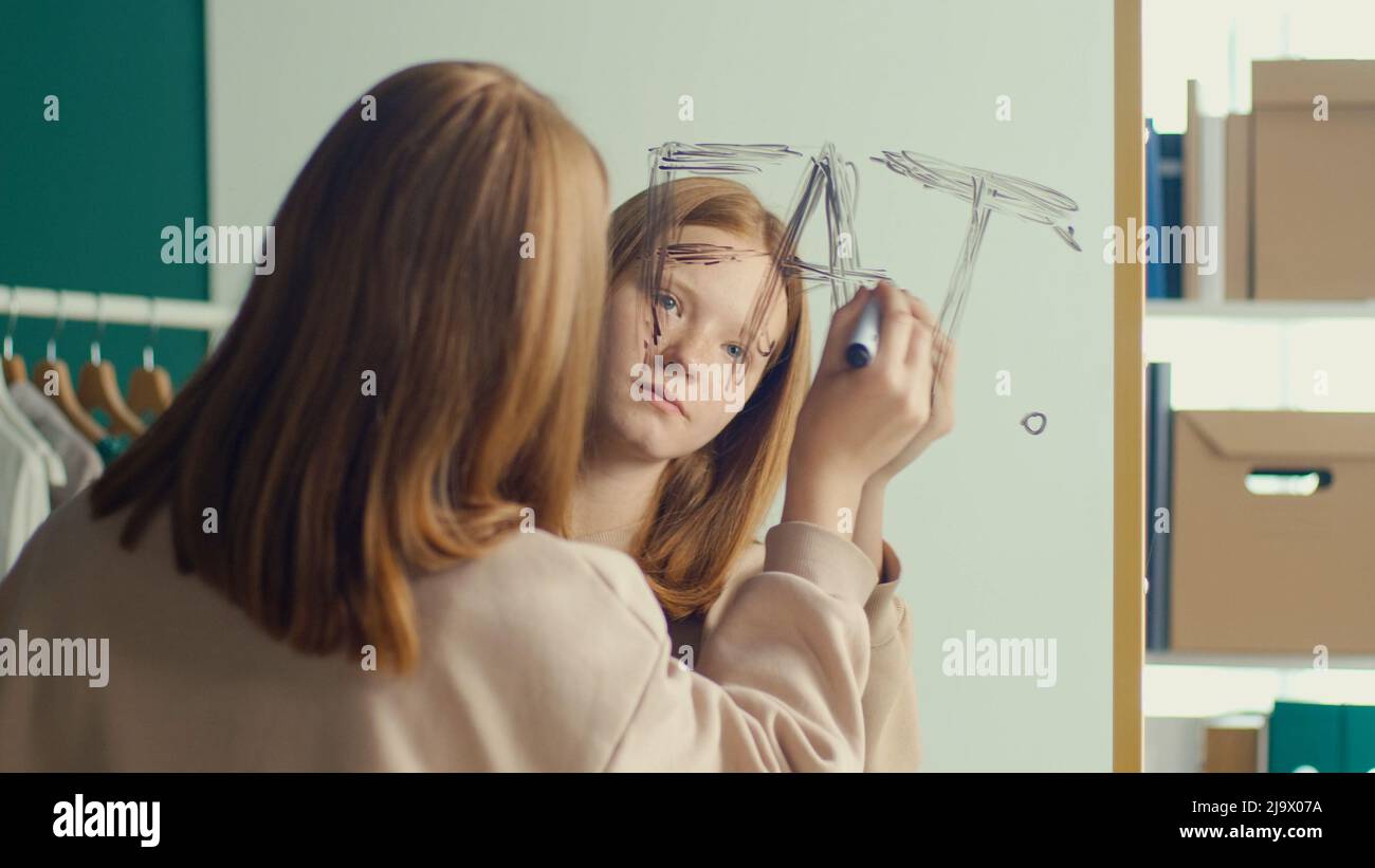 Reflection of a Red haired Teenage Girl Writing an Inscription on a ...