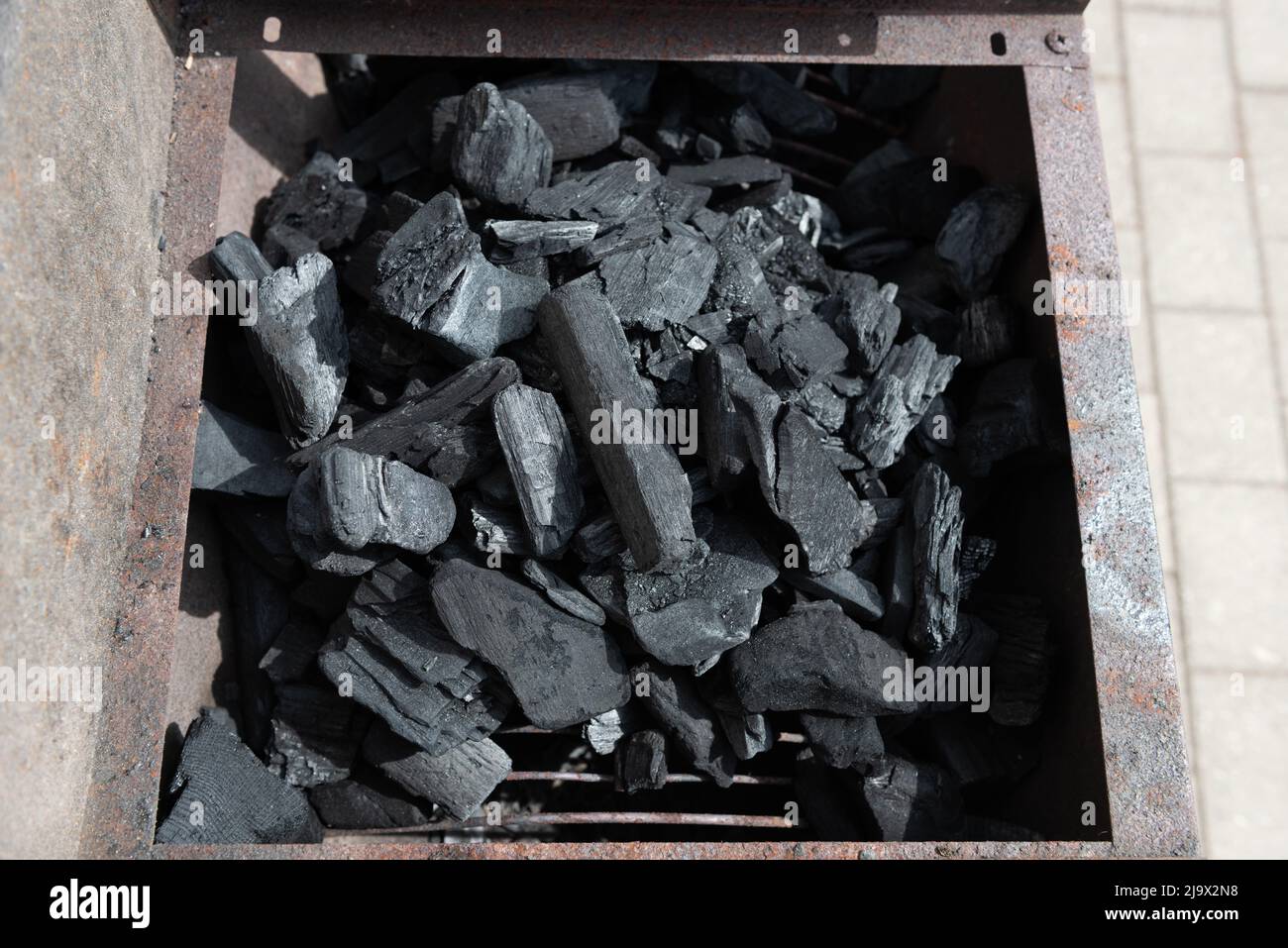 Coal on a barbeque ready to be lit Stock Photo - Alamy