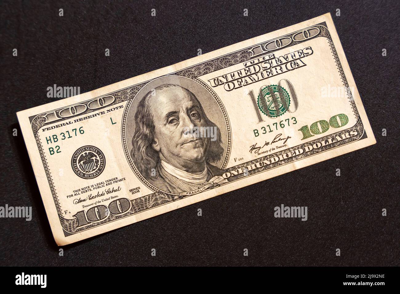 100 dollar bill on a black background . side view from above Stock ...