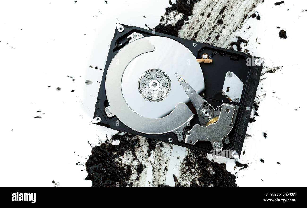Open computer hard disk drive on muddy background Stock Photo - Alamy