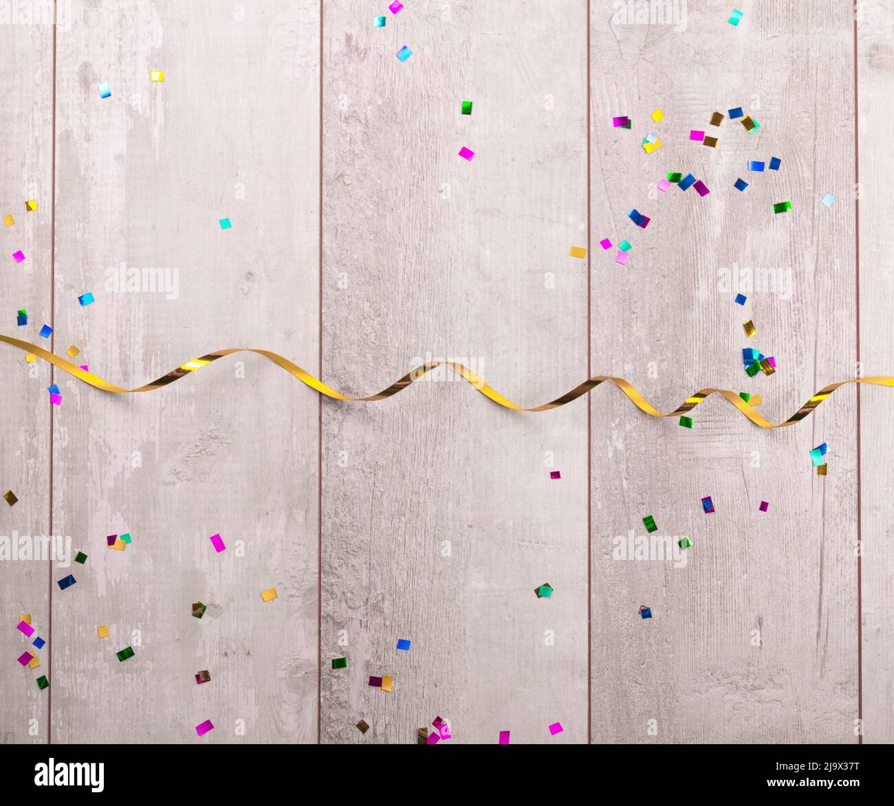 Wooden board with colorful streamers Stock Photo - Alamy