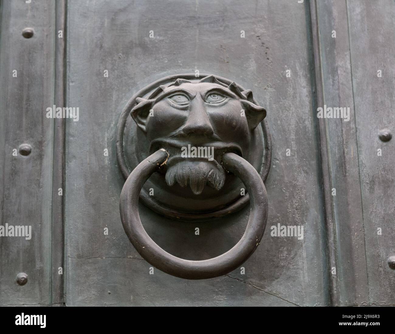 Ornate metal monster head door knocker on a door background Stock Photo ...