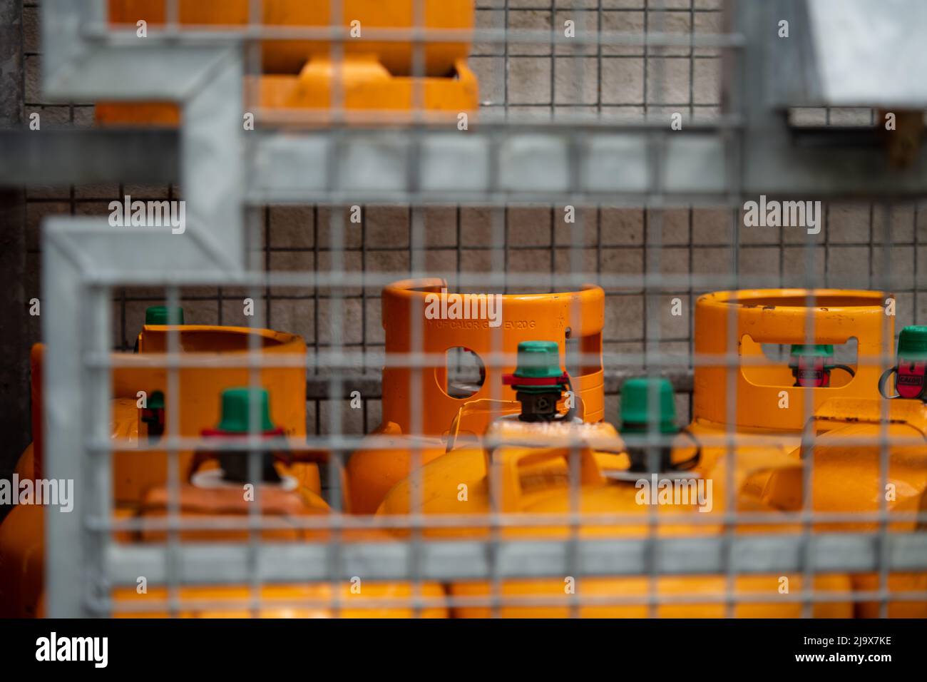 Natural gas stored in metal bottles, orange in color Stock Photo - Alamy