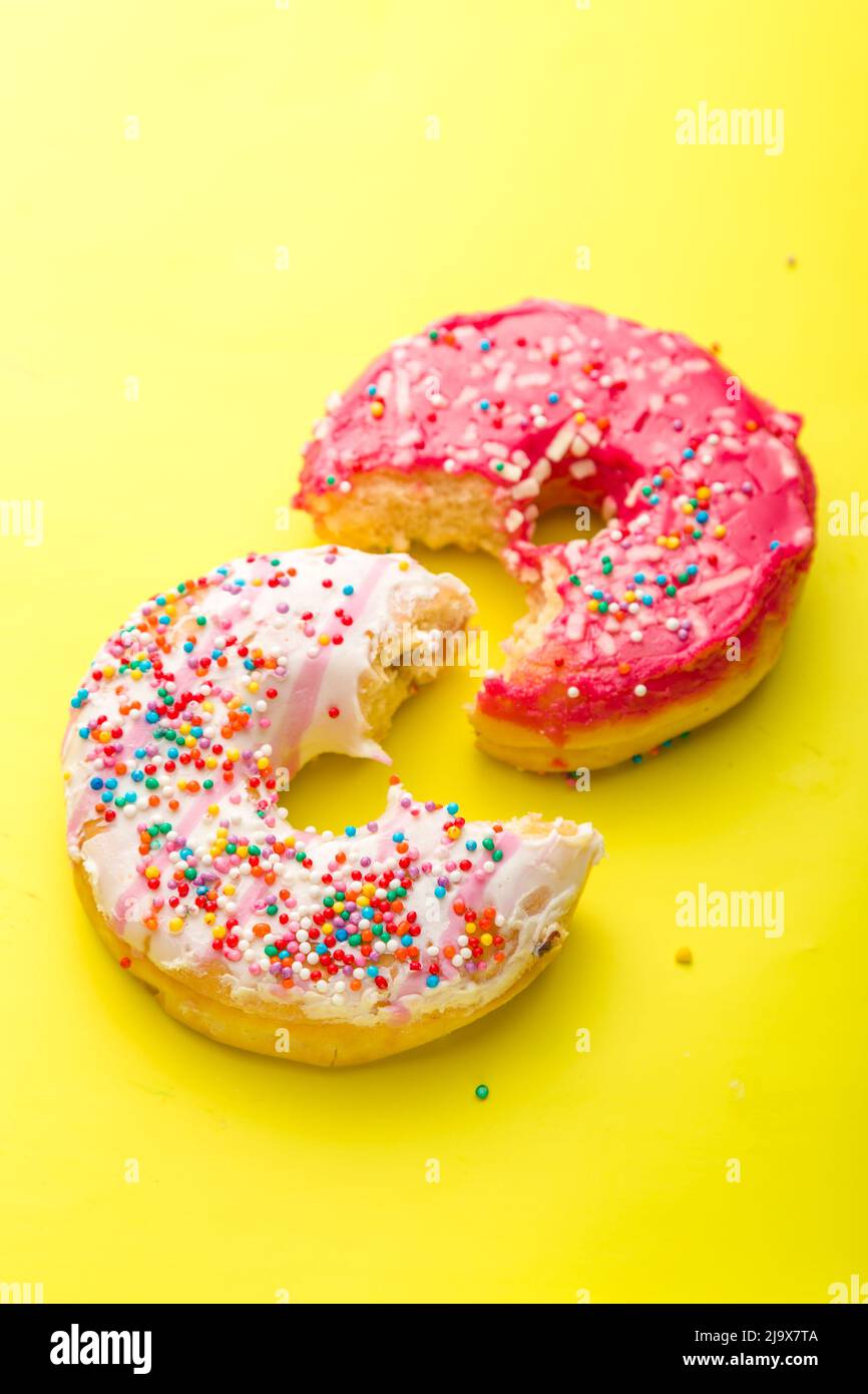 Donuts with icing on yellow background. Sweet donuts. Donuts background ...