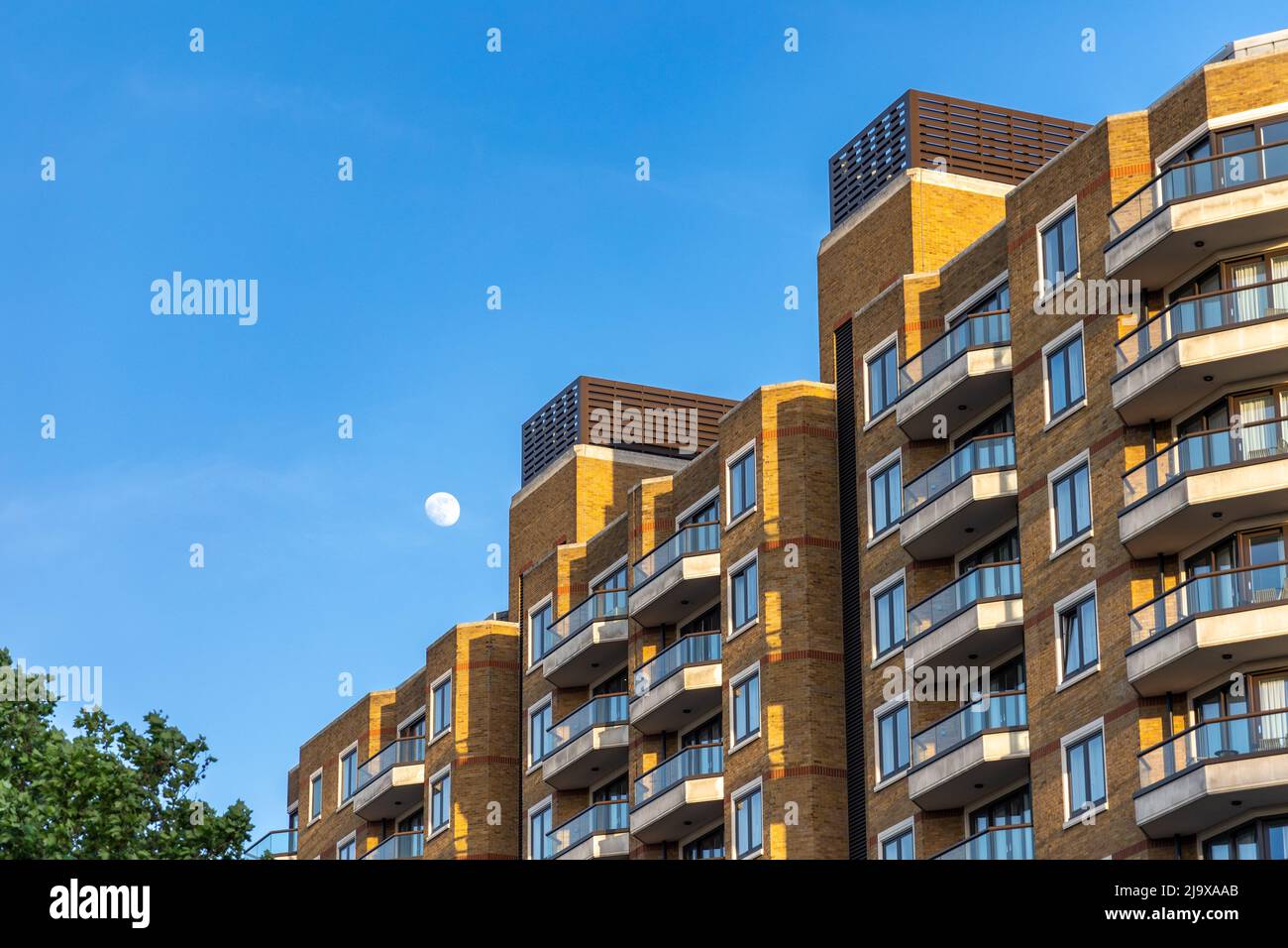 Close-up of full moon and high storey apartment building in South ...