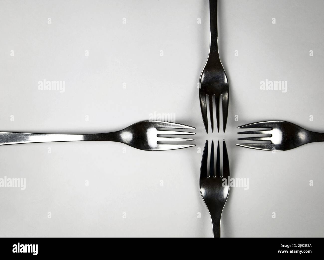 abstract background four forks in a cross Stock Photo - Alamy