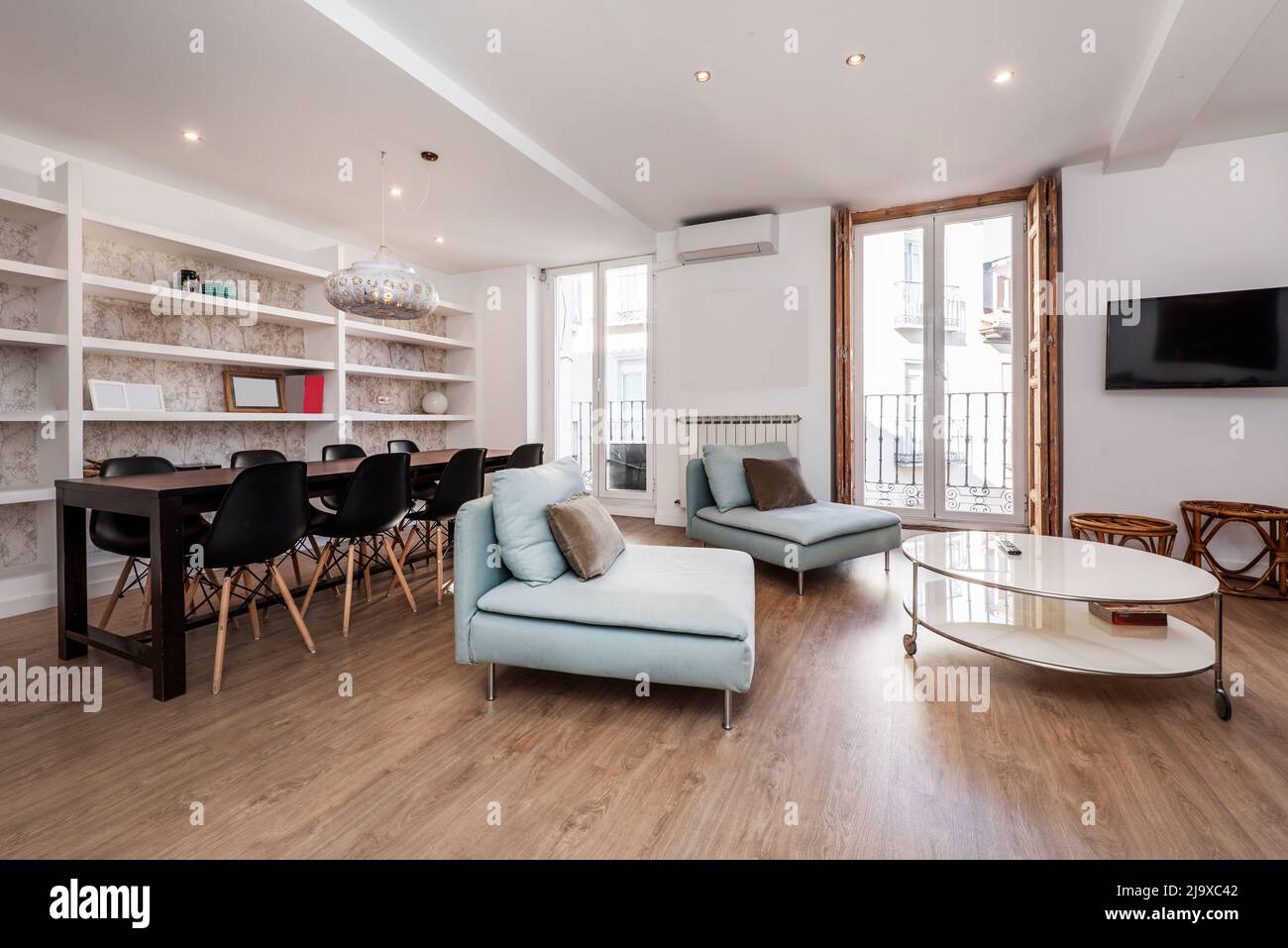 Studio apartment with long black wooden dining table and matching ...