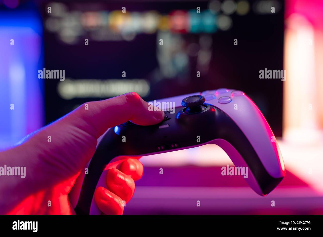 macro shot. Modern gamepad in the hand of a gamer. Neon lighting. Video ...