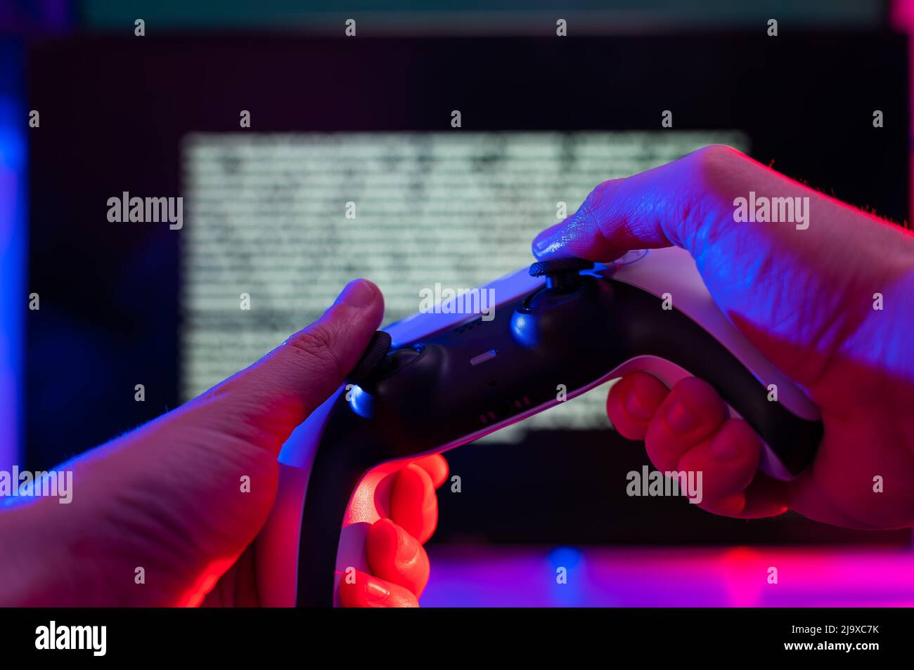Close-up. Video games. A gamer with a joystick in his hands plays a ...