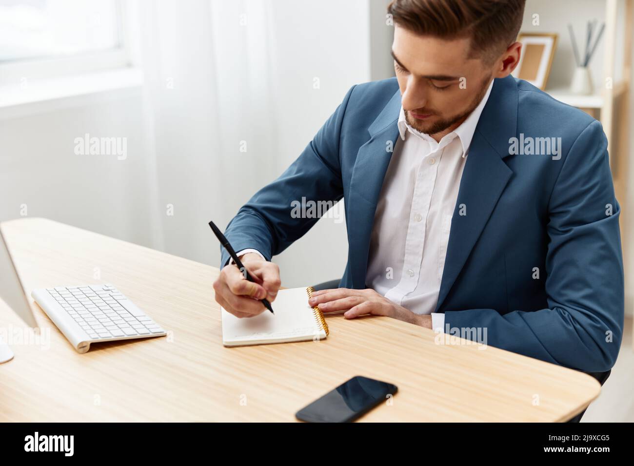 a man in a suit sitting at the computer work boss documentation ...
