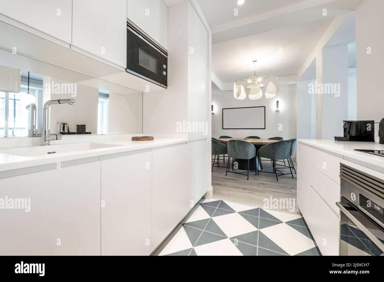 Kitchen of minimalist design with smooth white wood furniture and ...