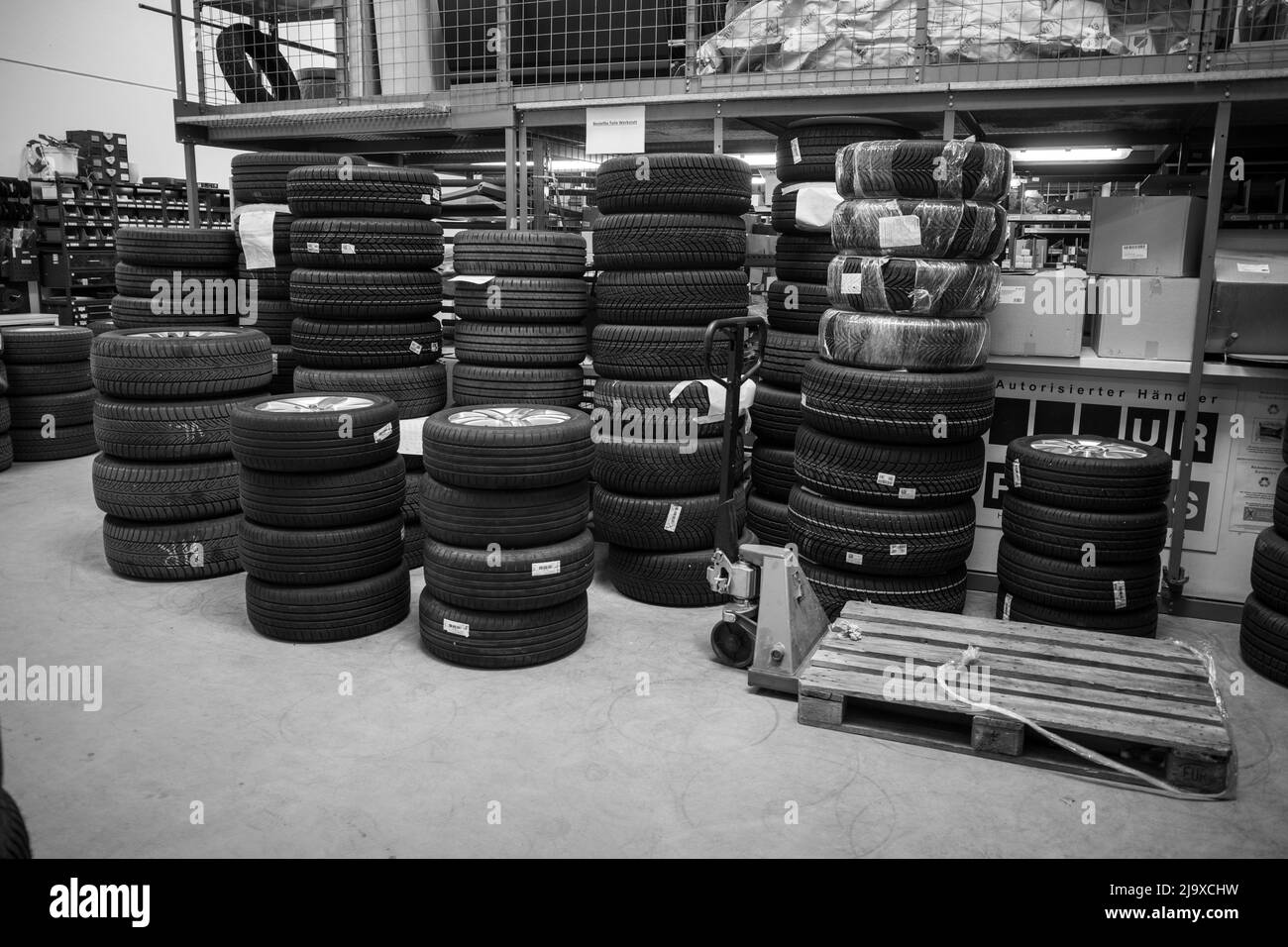 in the depot of a car repair shop there are many summer tires ready for ...