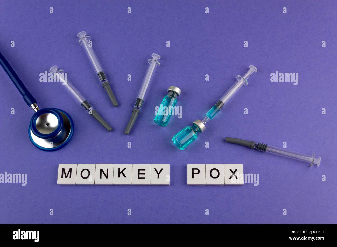 MONKEY POX. Words written on square wooden tiles stethoscope, medicine ...