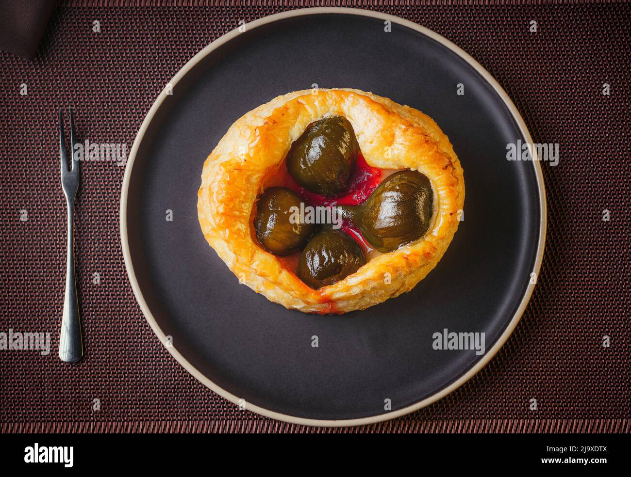 View of a puff pastry bread, fine pastry. Fig and puff pastry tart. The ...