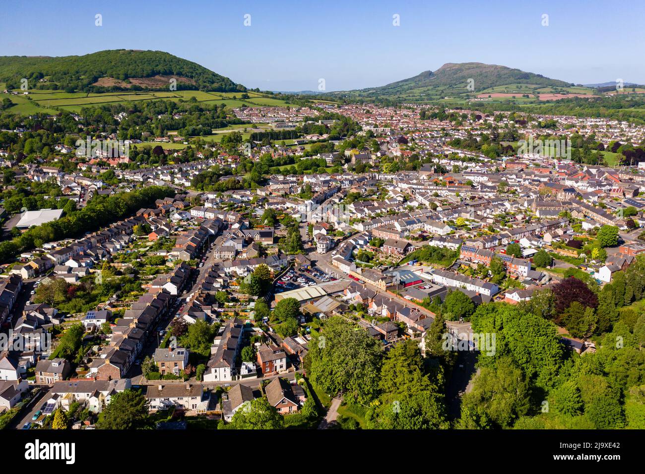 Aerial view of the Welsh town of Abergavenny surrounded by green fields ...