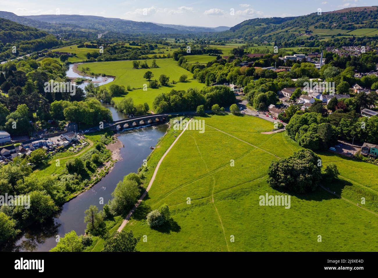 Aerial view of an old bridge over the River Usk separating the towns of ...