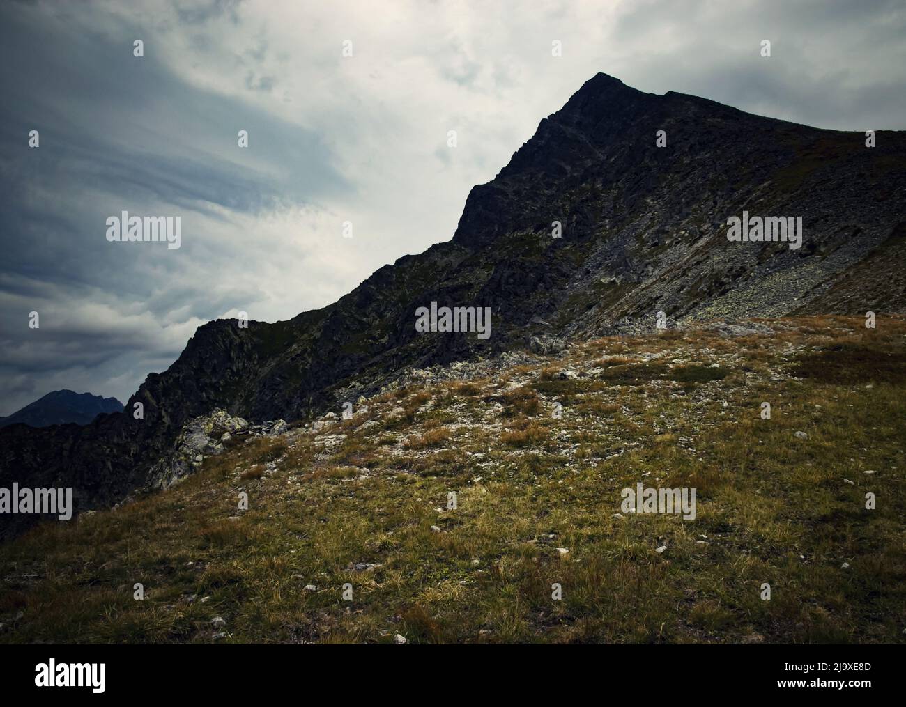 landscape background pointy mountain top with dramatic sky Stock Photo ...