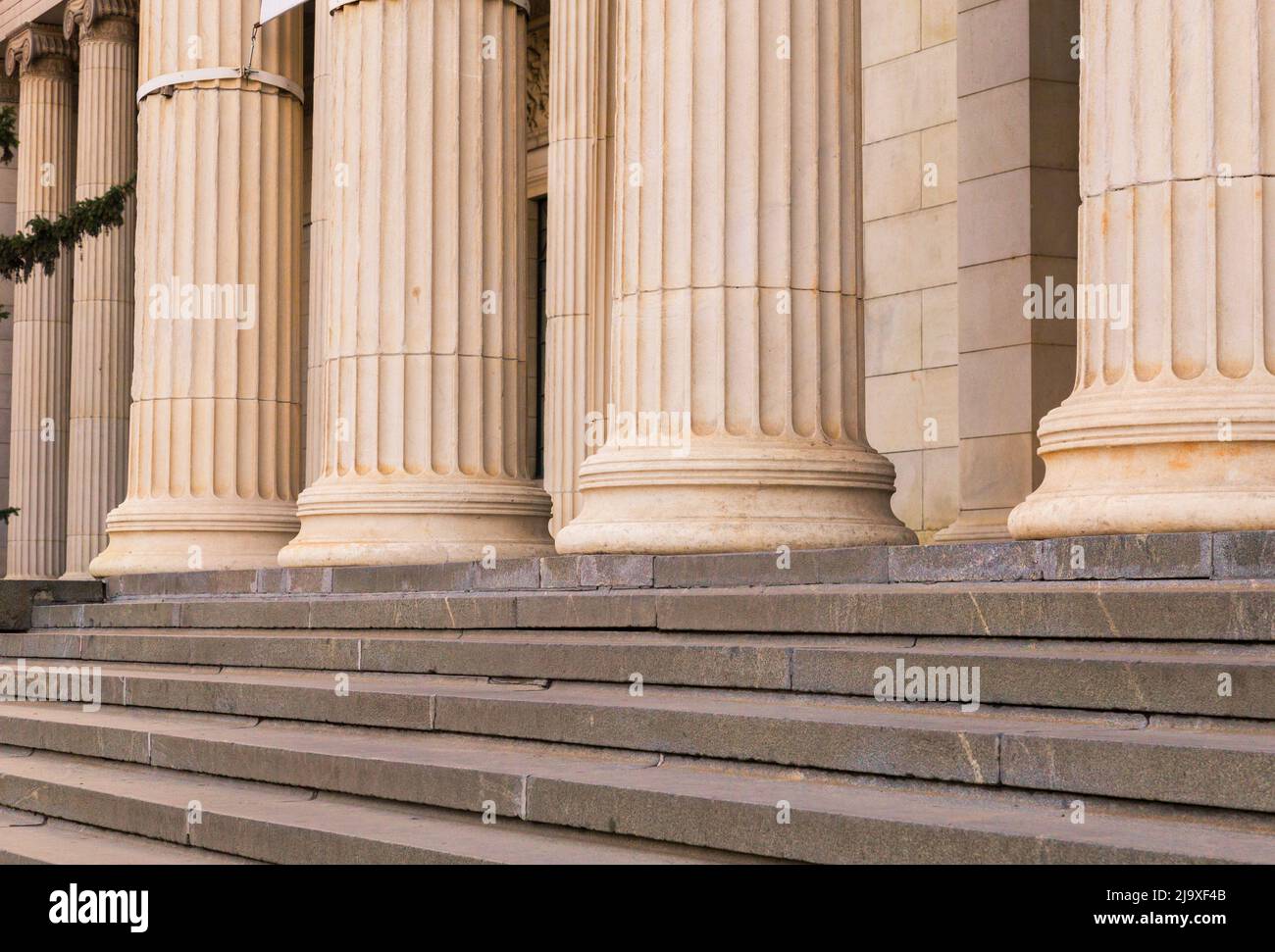Many old greek columns in a row Stock Photo - Alamy