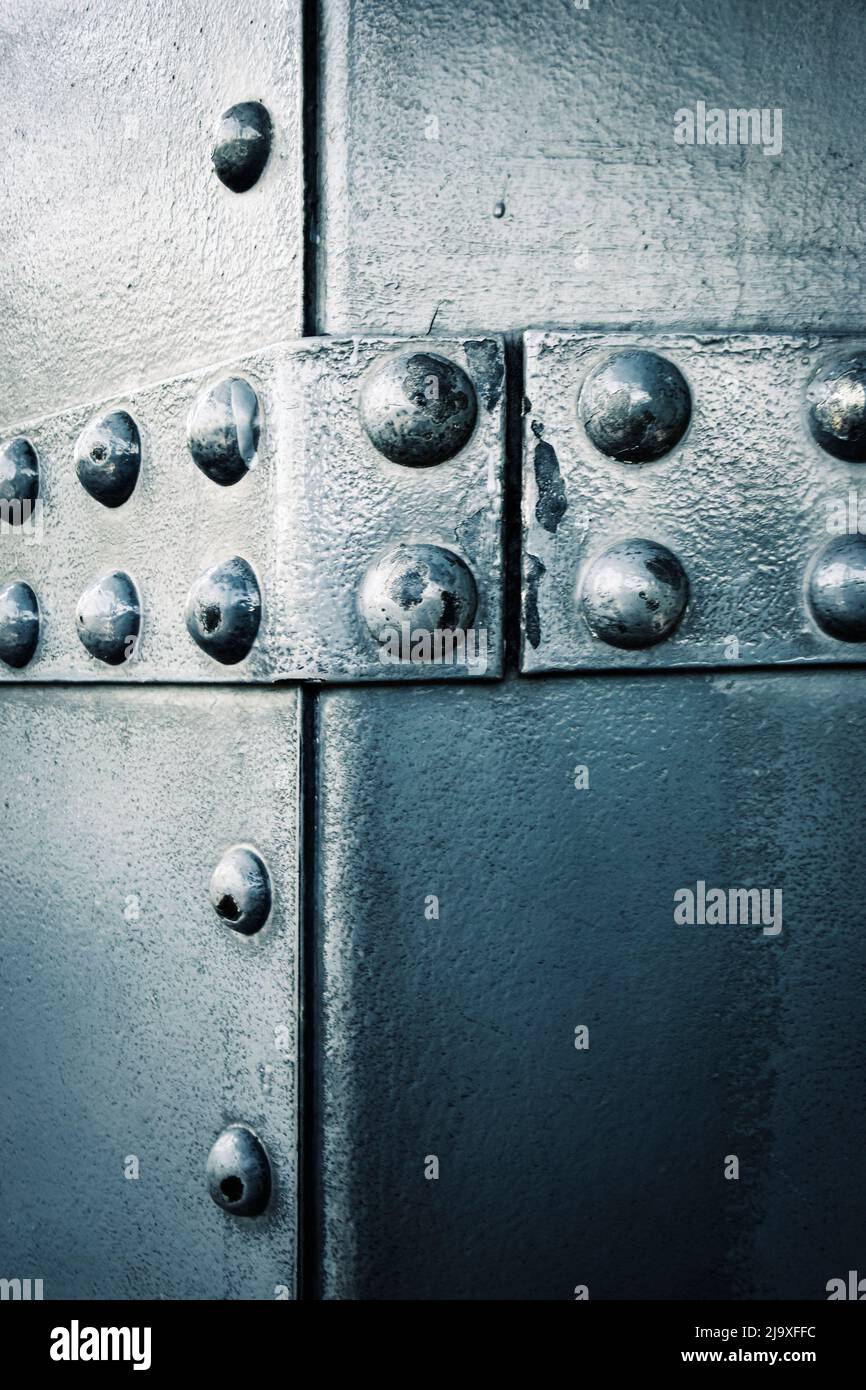 background or texture dark riveted pieces of iron Stock Photo - Alamy