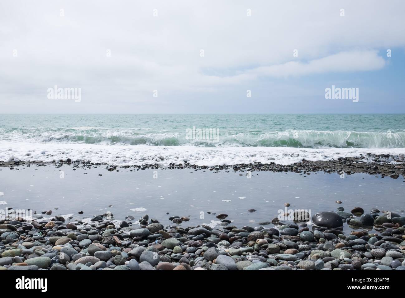 Sea stones background in the seaside on a beach. A close up view of ...