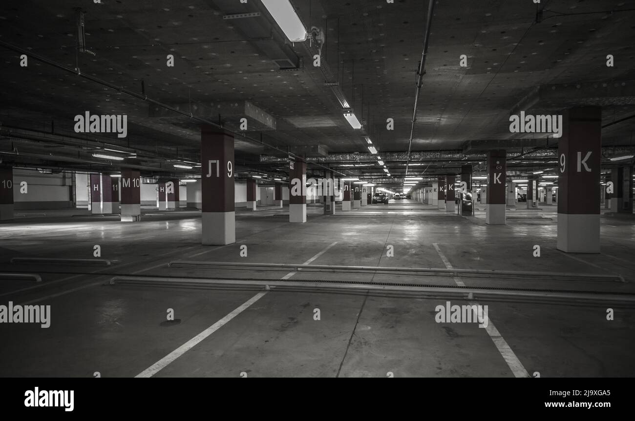 Parking garage, underground interior with a few parked cars Stock Photo ...