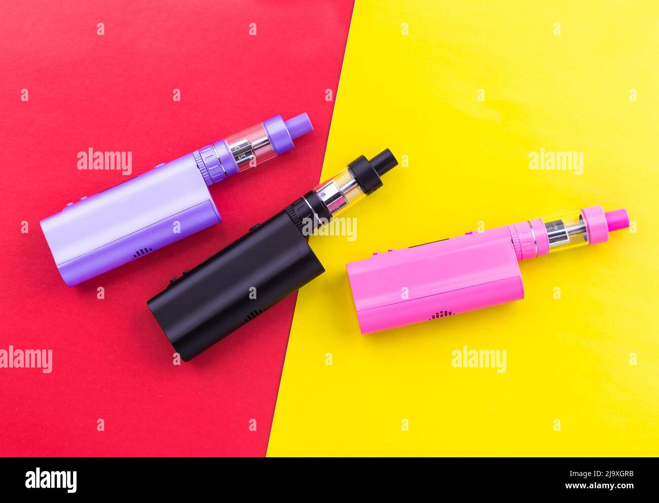 Vaping devices color background Stock Photo - Alamy