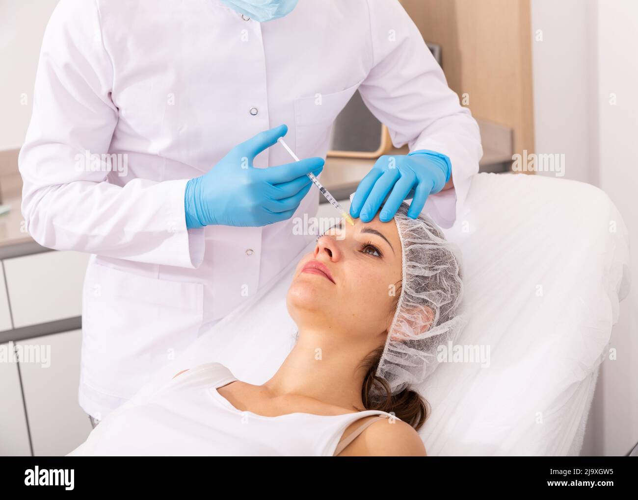 Female client during face mesotherapy Stock Photo - Alamy