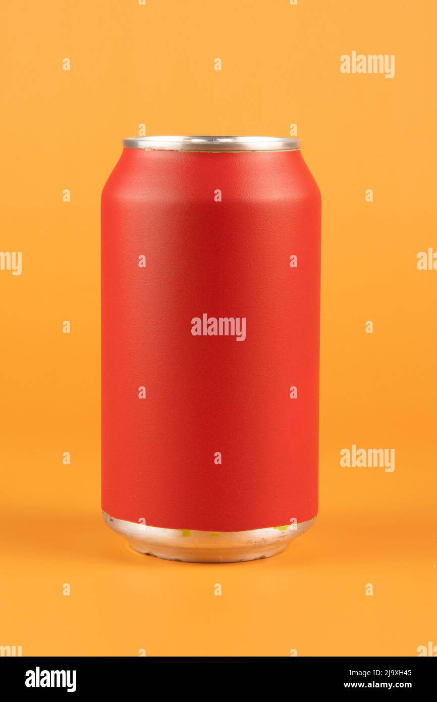 red aluminum can isolated on orange background Stock Photo - Alamy