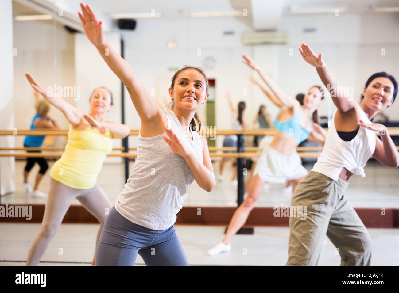 Women practicing vigorous dance movements in group dance class Stock Photo - Alamy