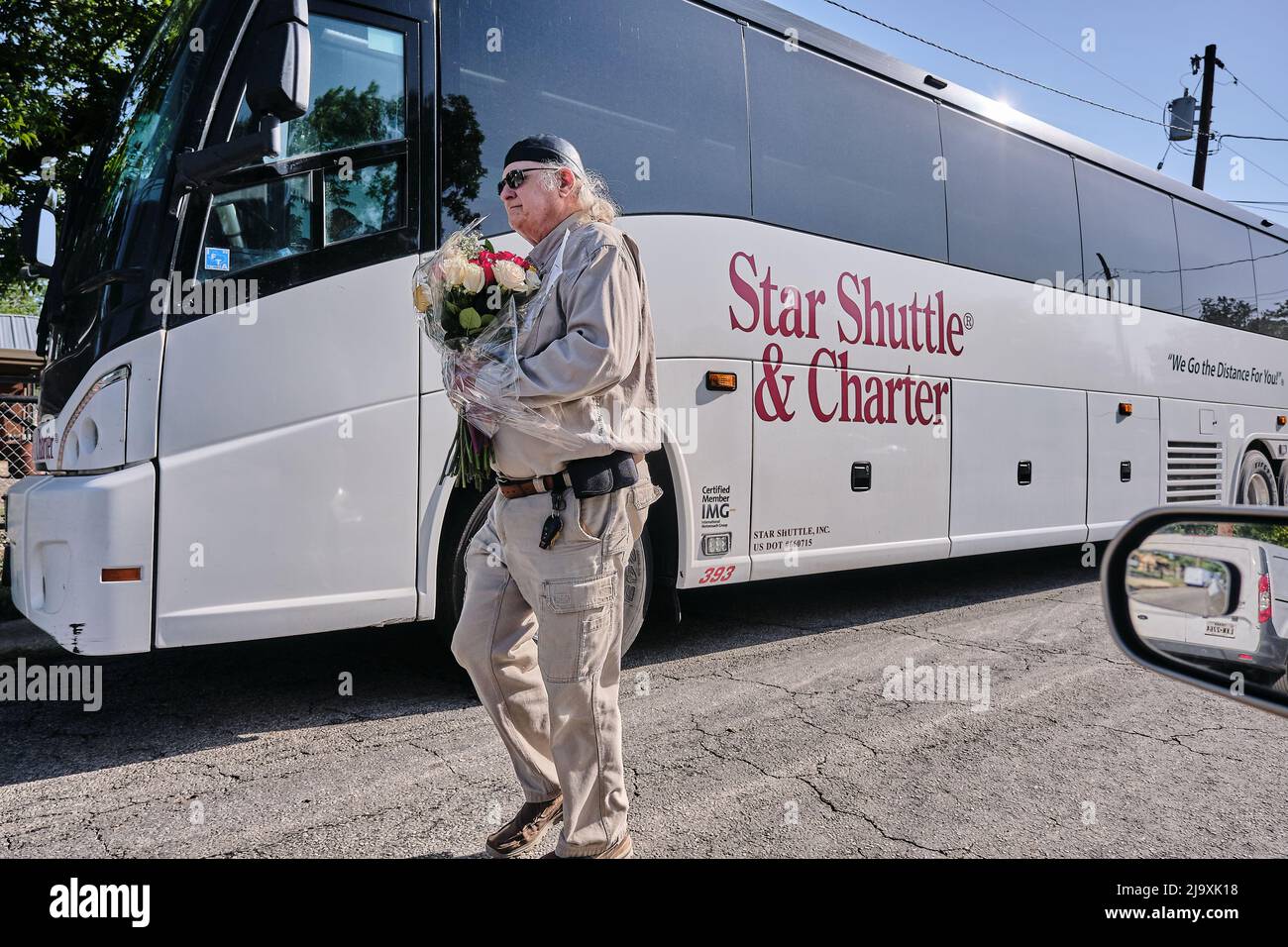 Uvalde, Texas, USA. 25th May, 2022. A man carries flowers as residents ...