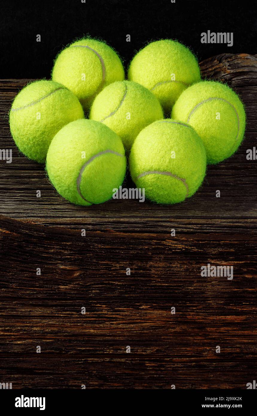 Yellow tennis balls on wooden background, space for text, sport and ...