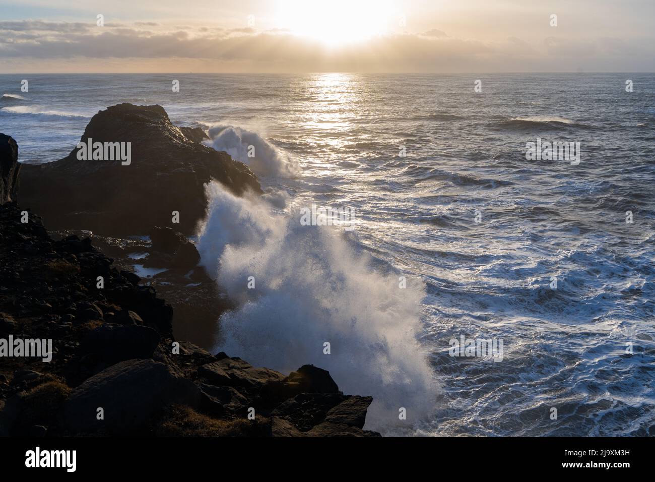 Wave crashing into the cliff Stock Photo - Alamy