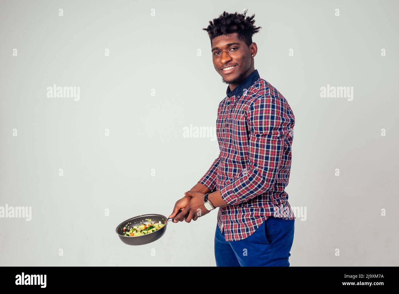 African American chef holding a frying pan wizard man is cooking magic ...