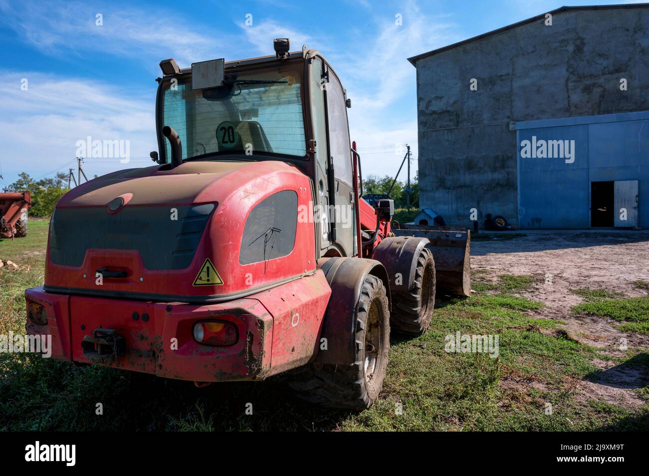 Modern red front wheel loader on a farm Stock Photo - Alamy