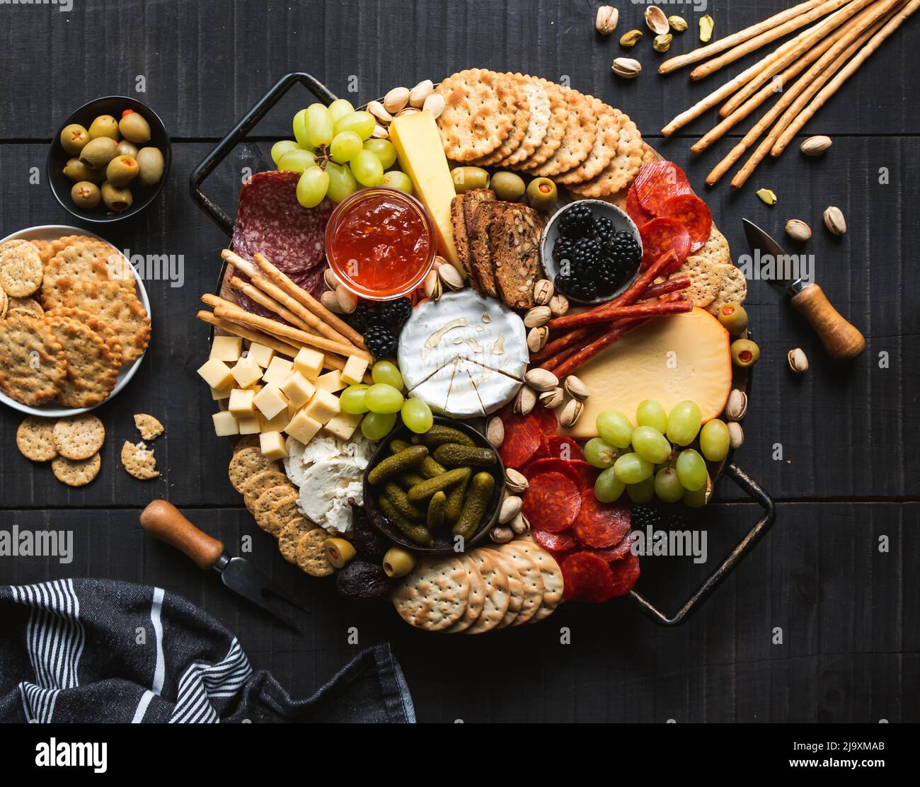 Overhead of charcuterie board of cheese, meat, crackers and fruit Stock ...