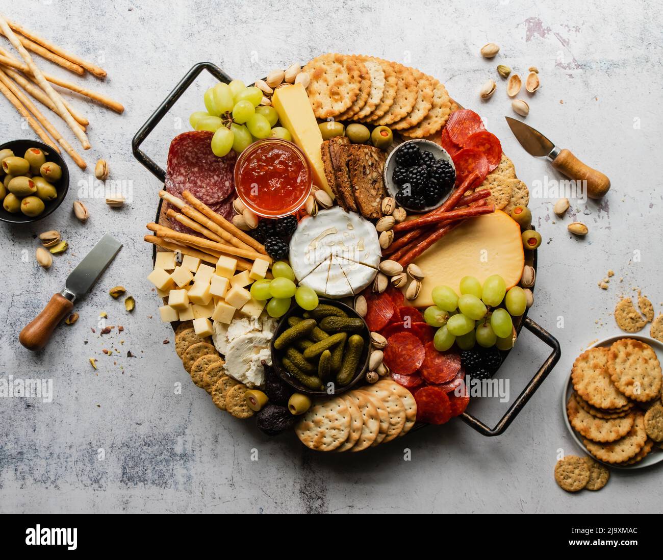 Overhead of charcuterie board of cheese, meat, crackers and fruit Stock ...