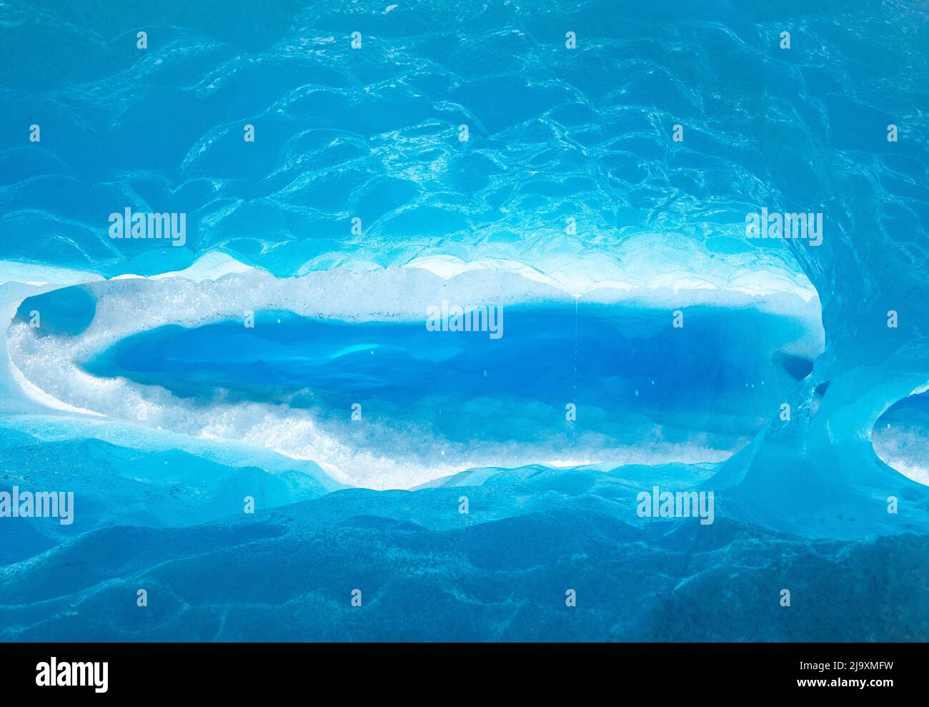 A small ice cave glows on the Perito Moreno glacier Stock Photo - Alamy