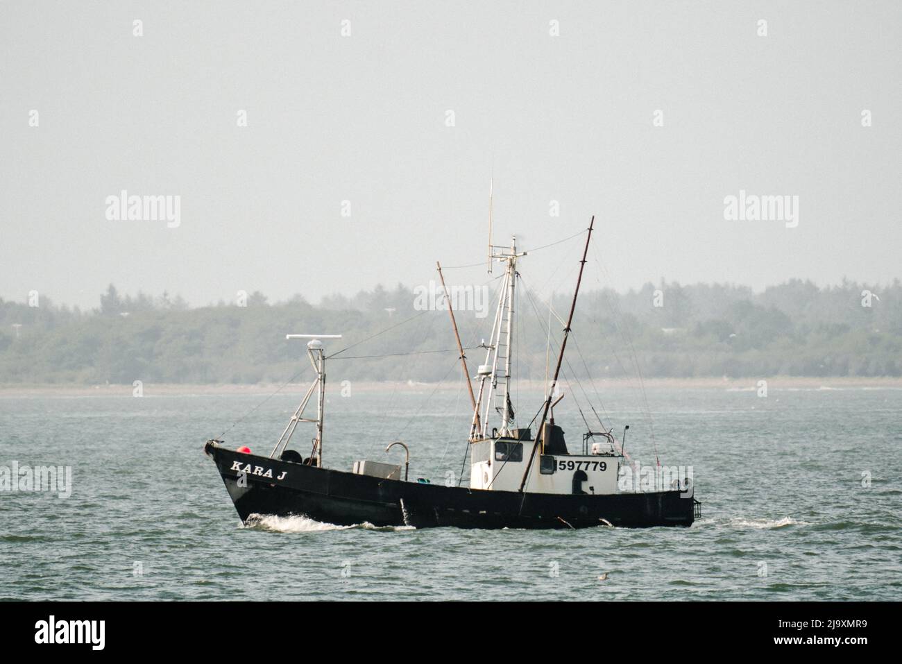 Side view of a fishing boat heading out to see Stock Photo - Alamy