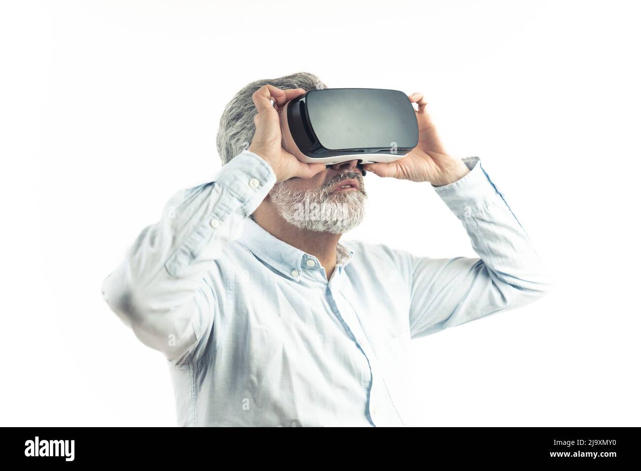 Virtual Reality concept. Caucasian middle-aged gray-haired man in a ...