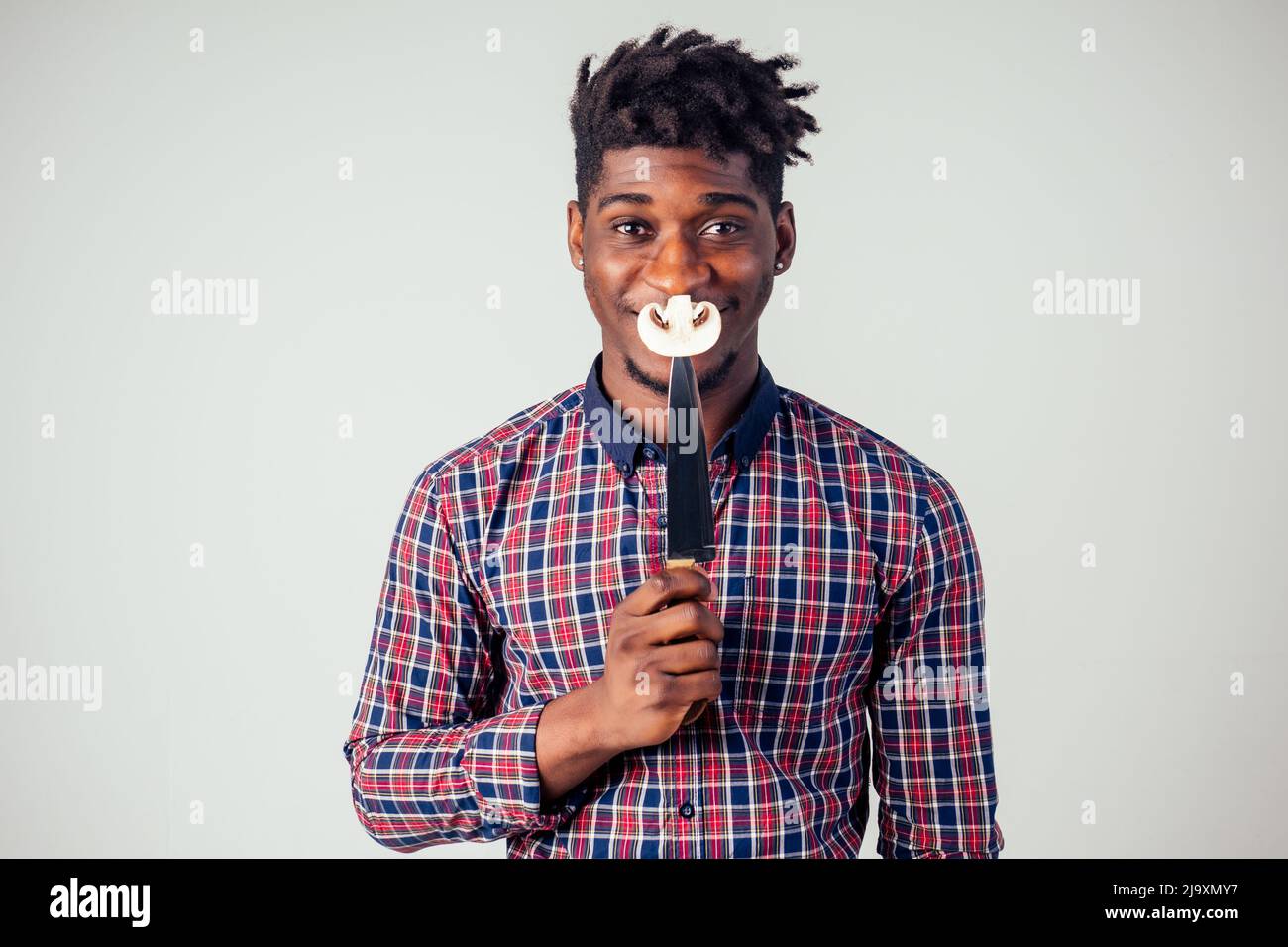 African American chef man cutting vegetables mushroom in kitchen on ...