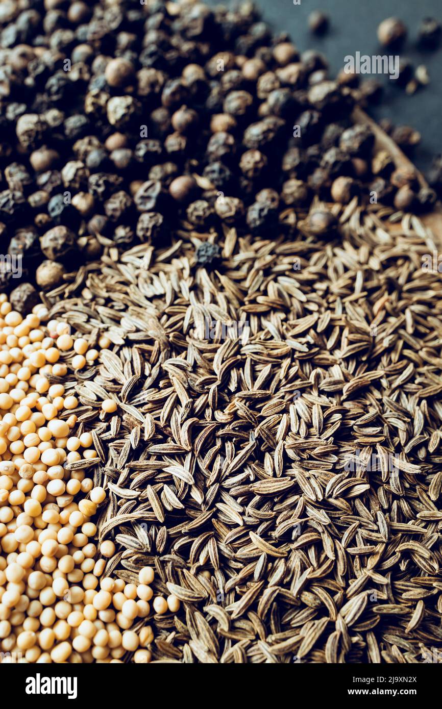Cumin, black pepper and mustard seeds Stock Photo - Alamy