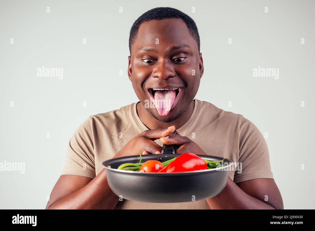 african american chef kitchener holding a frying pan wizard man cooking magic flying food salad ...