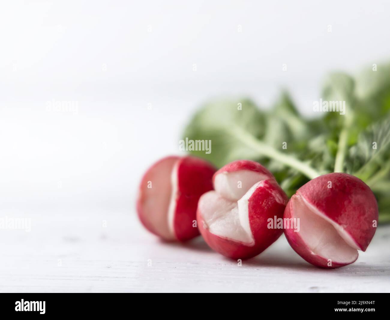 Cracked radish on a white wooden surface Stock Photo - Alamy