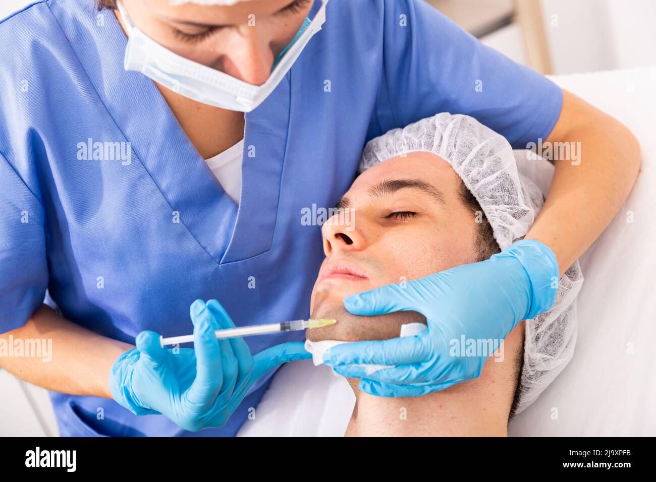 Man getting face injections at aesthetic clinic Stock Photo - Alamy