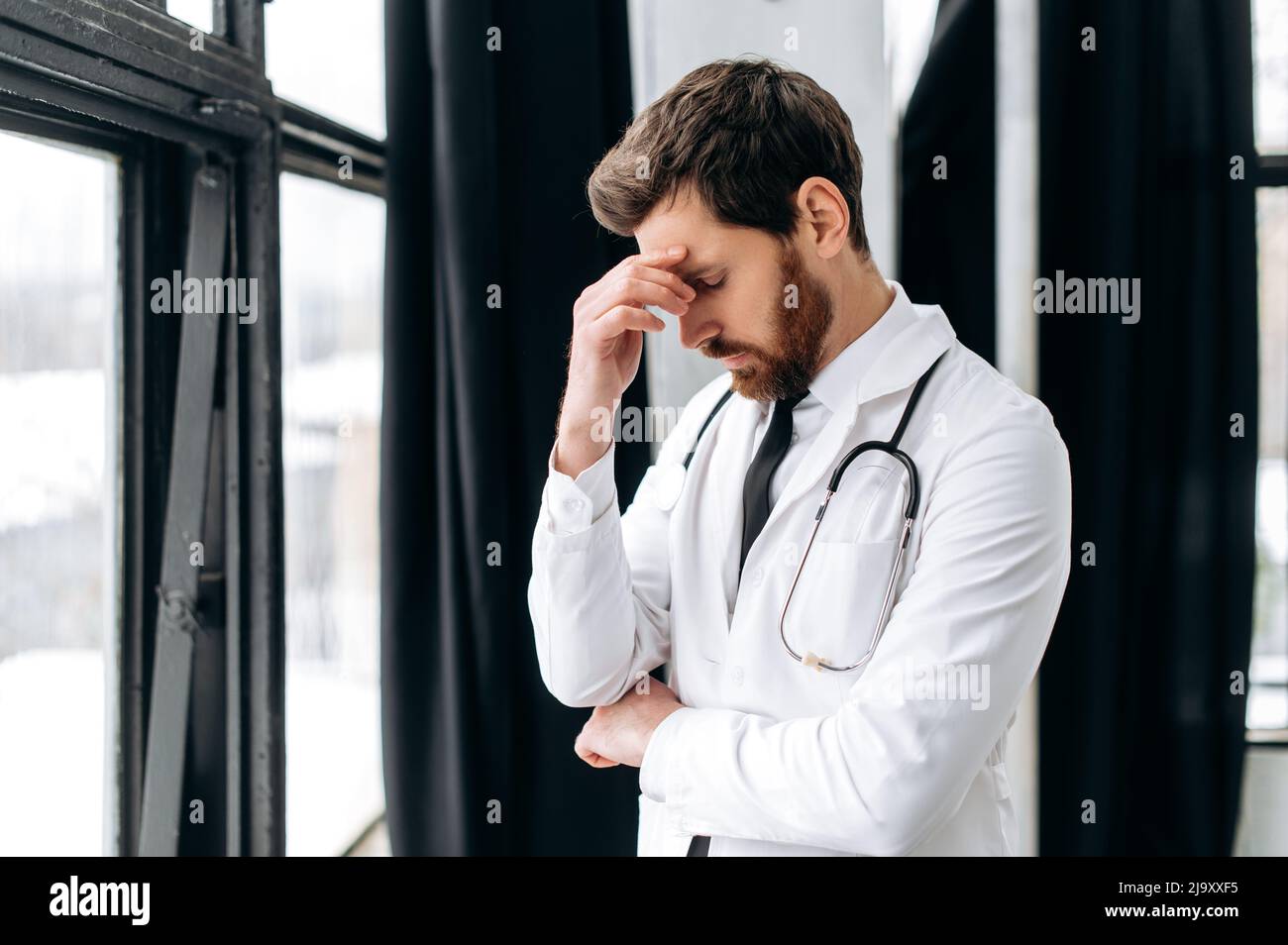 Photo of a sad tired overworked male general medicine doctor, in a ...
