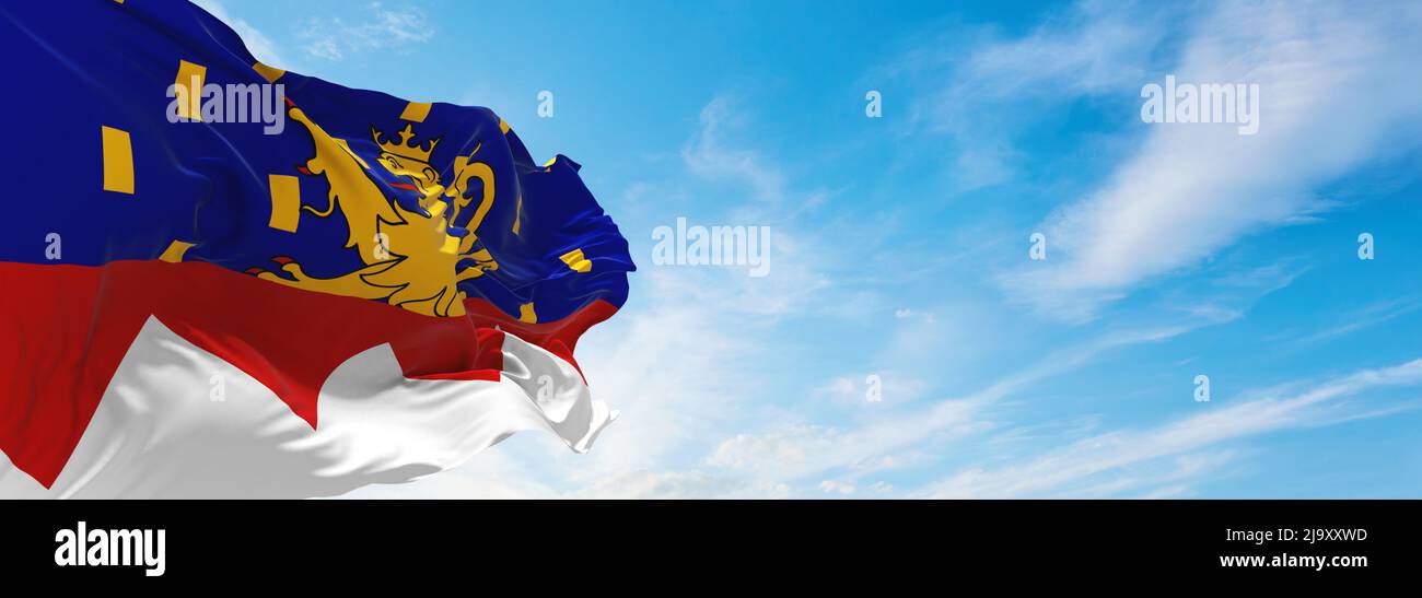 flag of Jura, France at cloudy sky background on sunset, panoramic view ...