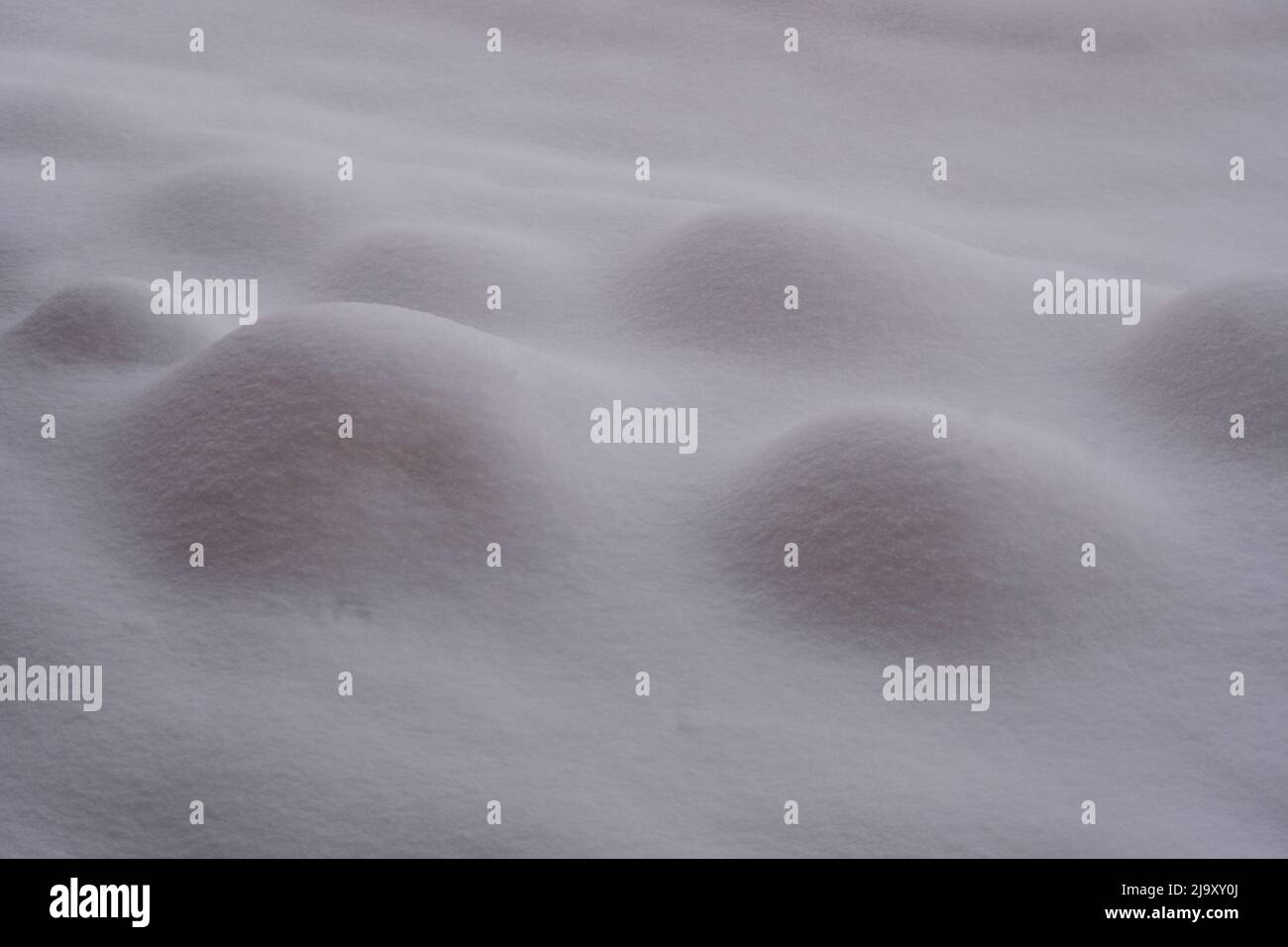 Round river rocks covered in snow after a winter storm Stock Photo - Alamy