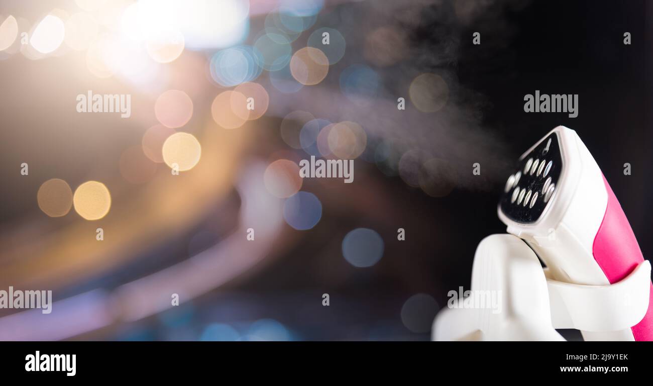 Close up of electric hand steam generator while it's hot and steam ...