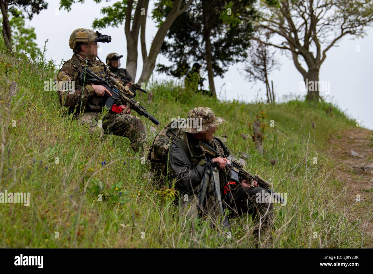 U.S. Navy SEALs conduct a tactical pause while on patrol during ...